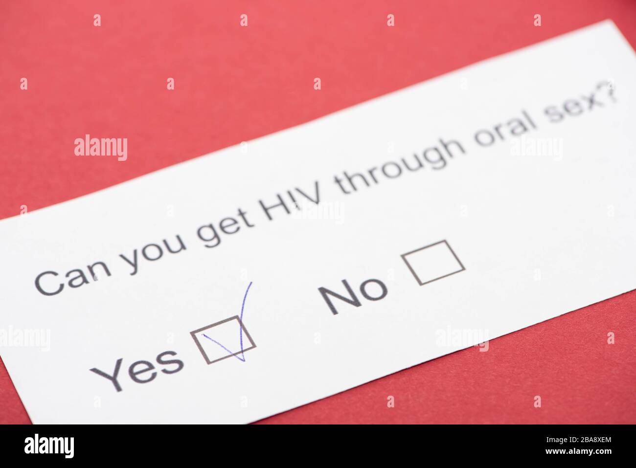 paper card with HIV questionnaire on red background Stock Photo - Alamy