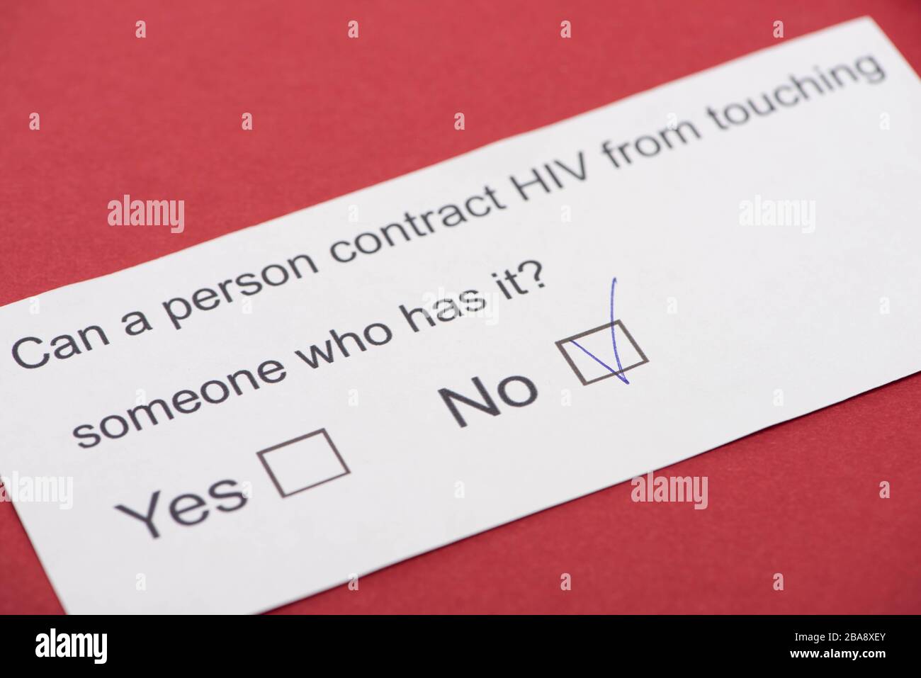 paper card with HIV questionnaire on red background Stock Photo - Alamy