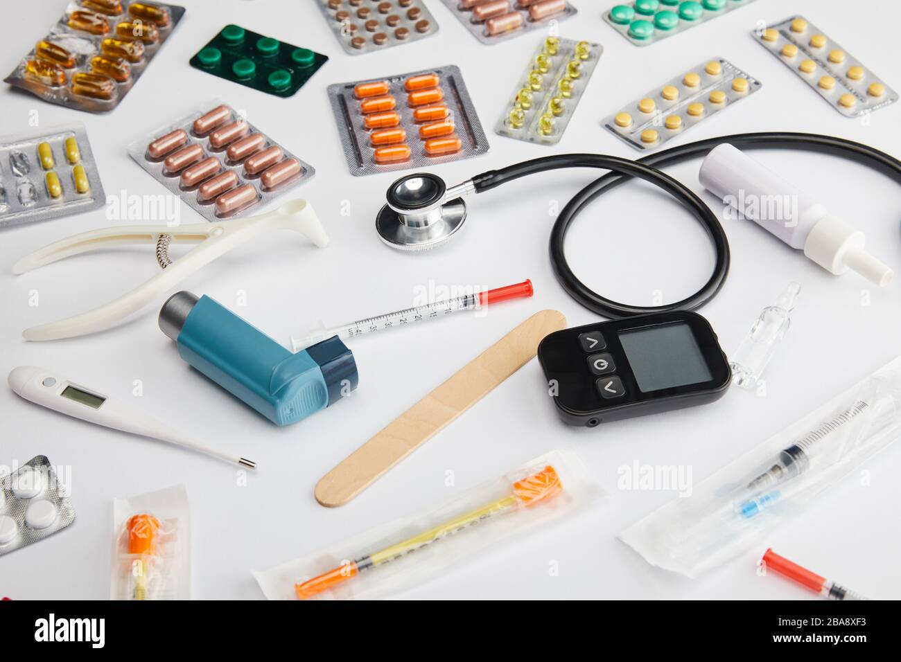 High angle view of colorful medicines, stethoscope, thermometer and ...