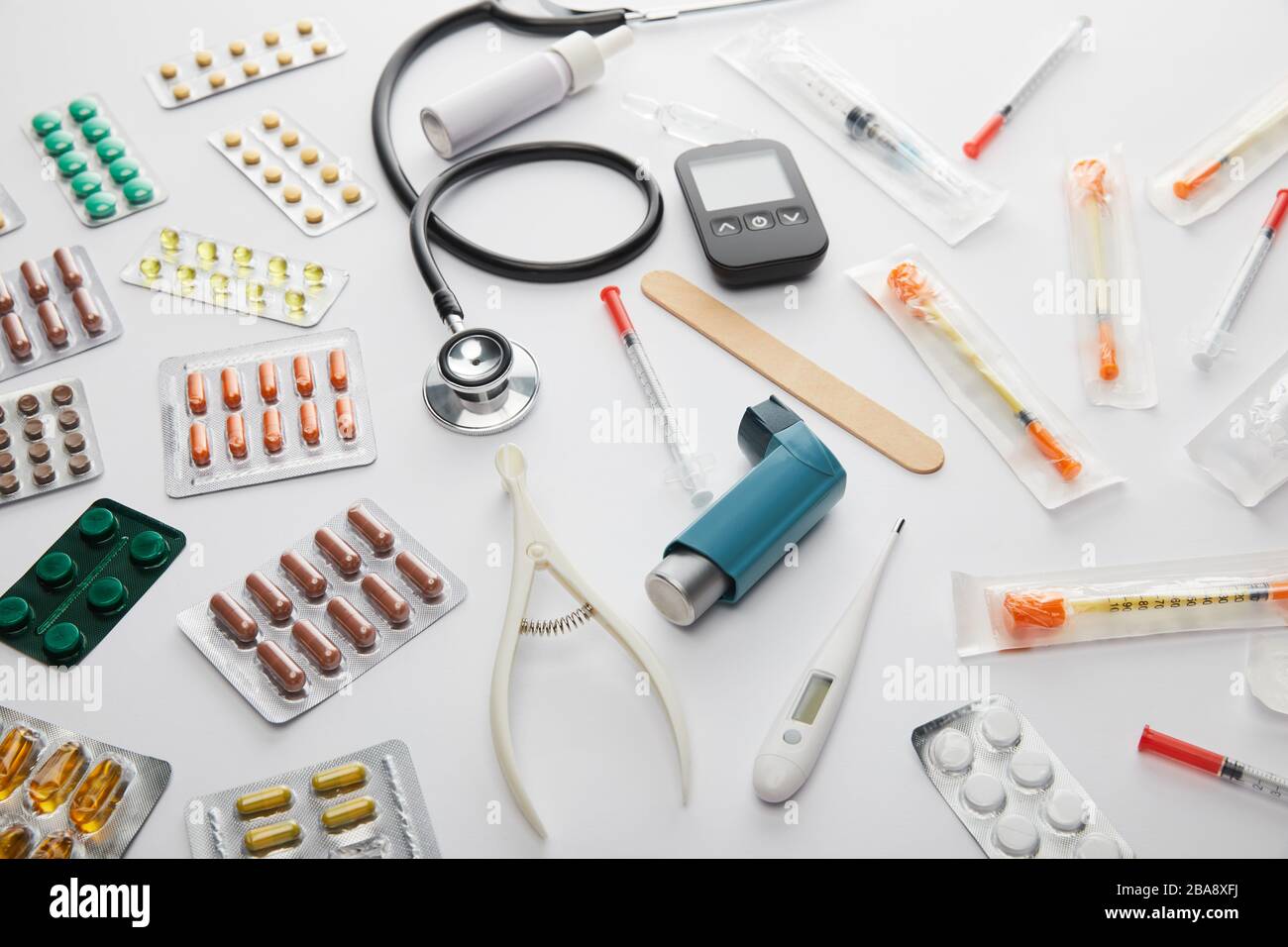 High angle view of medicines, stethoscope, thermometer and medical ...