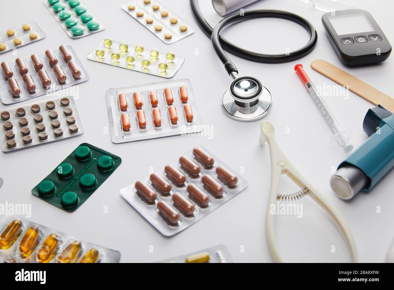 High angle view of medical objects and medicines on white background ...