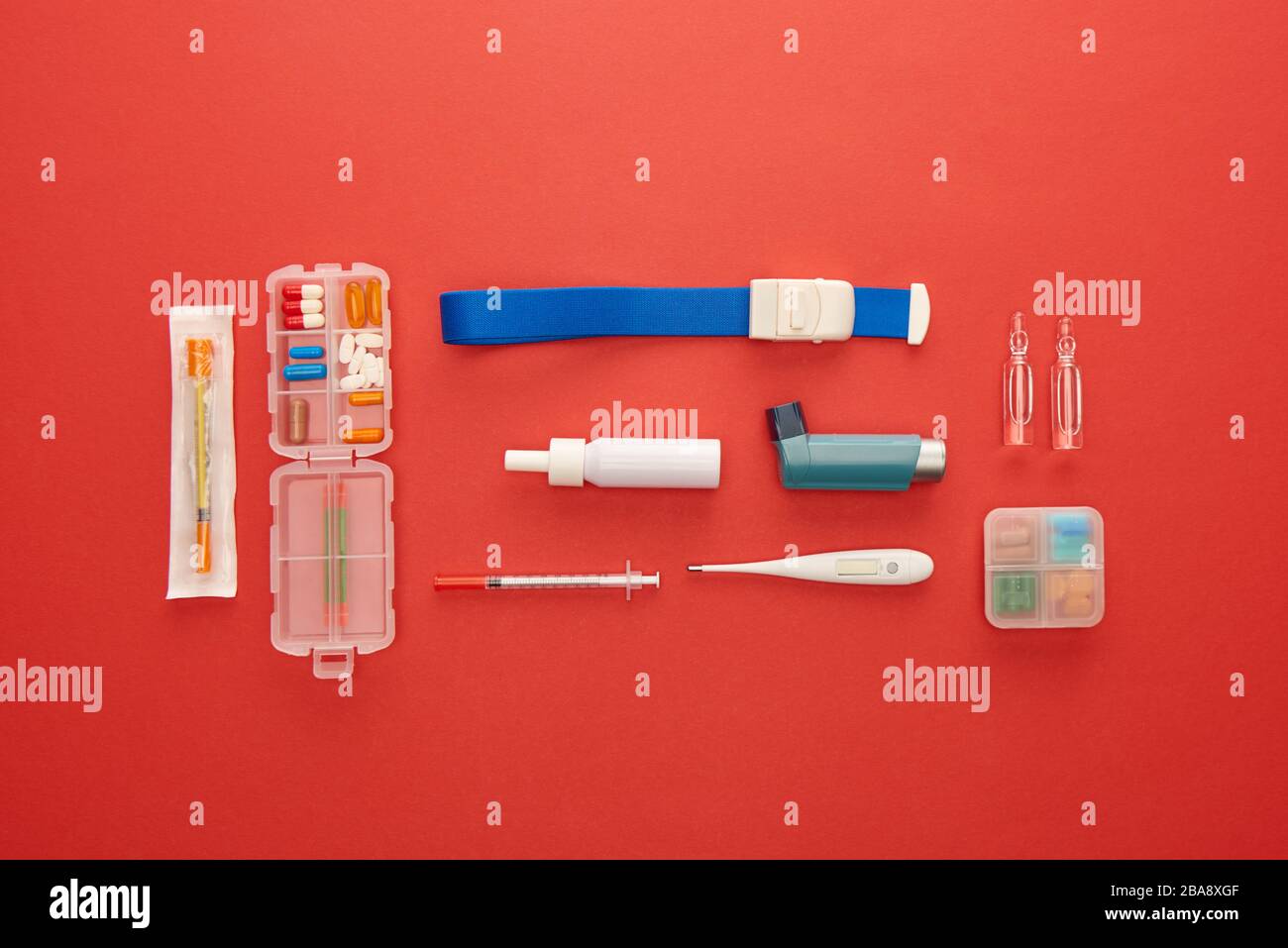 Flat lay with medicines and medical objects on red background Stock ...