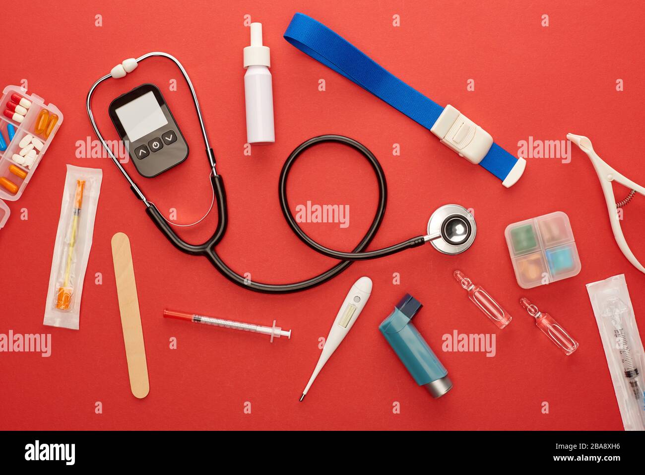 Top view of stethoscope, asthma inhaler, medicines and medical objects ...