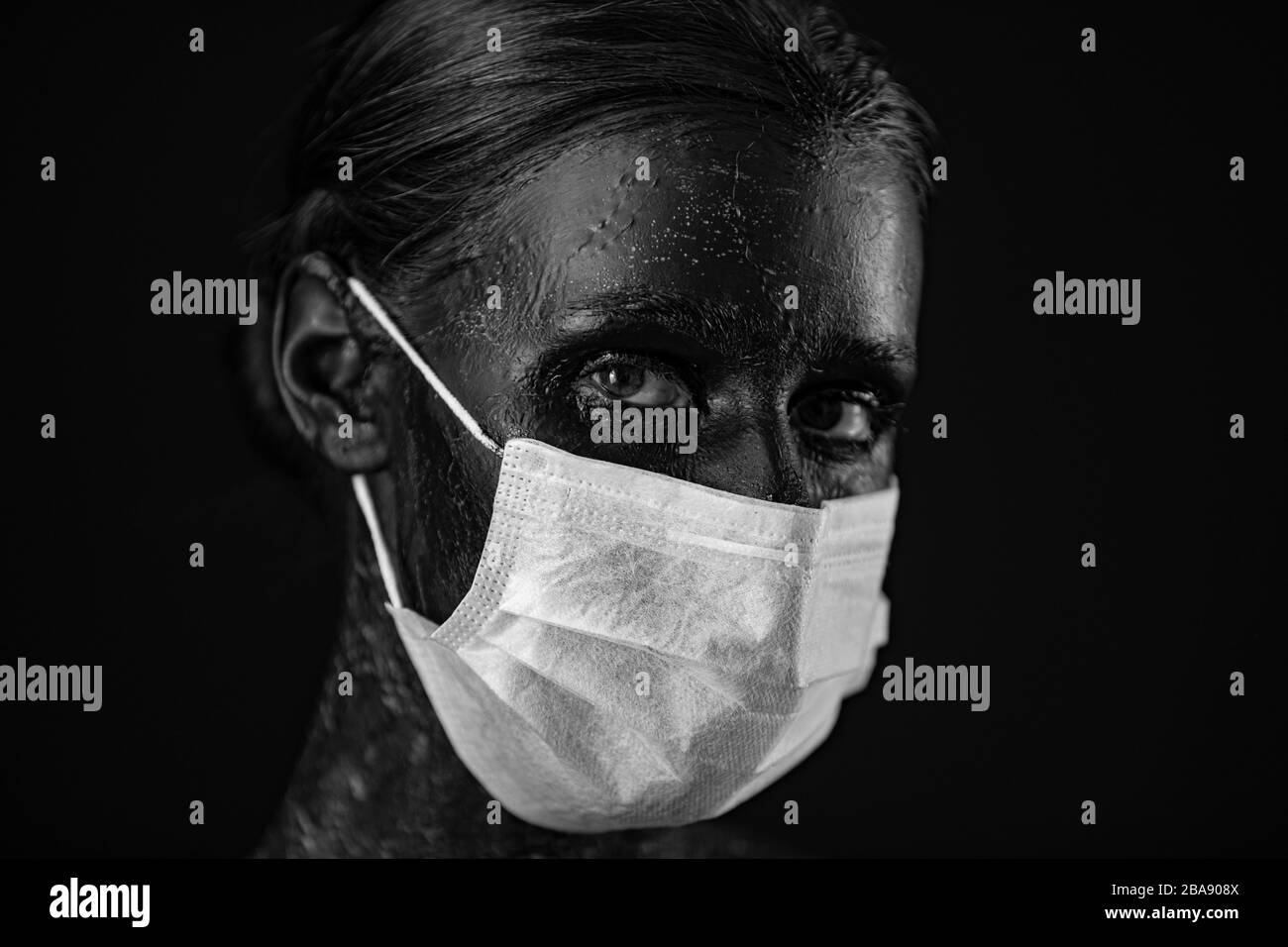 Coronavirus, masked woman. Studio portrait of a young woman wearing a ...