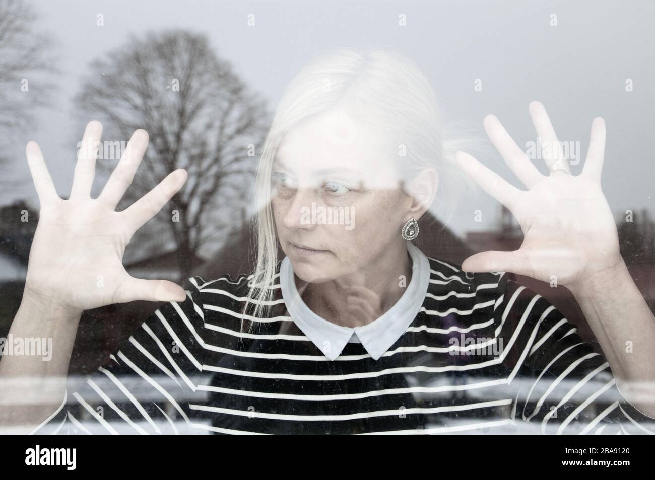 Woman in isolation behind the window. Person looking through window in ...