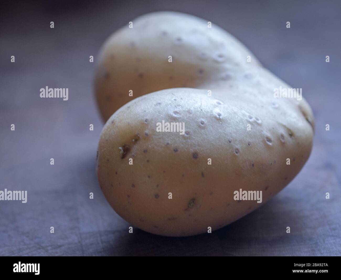 Isolated close up of a single heart shaped raw potato in color Stock ...