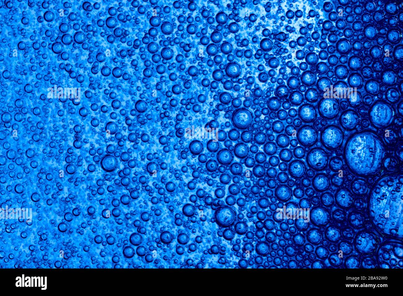 Bubbles in blue oil Stock Photo - Alamy