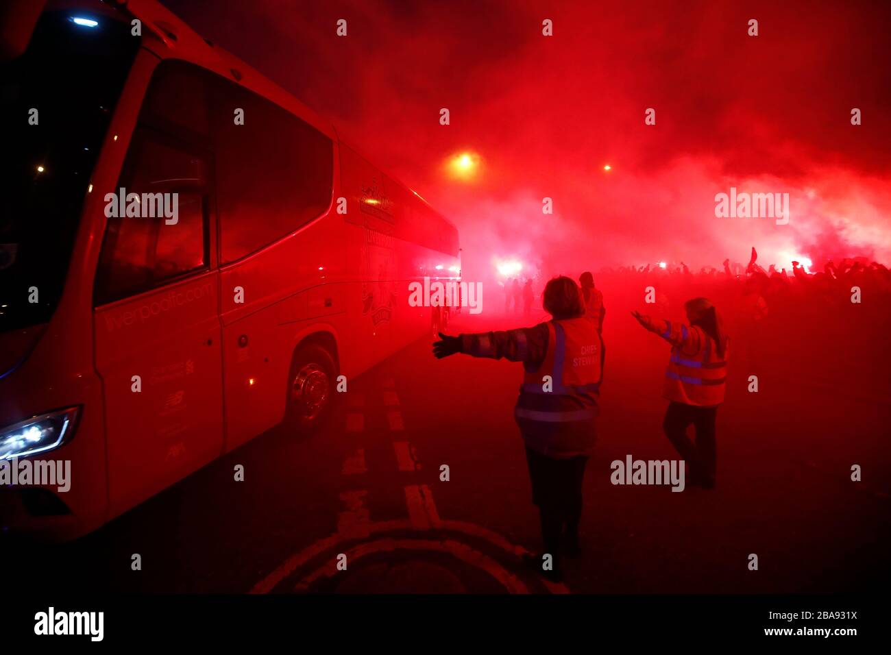 The Liverpool bus arrives ahead of the match as fans let off flares ...
