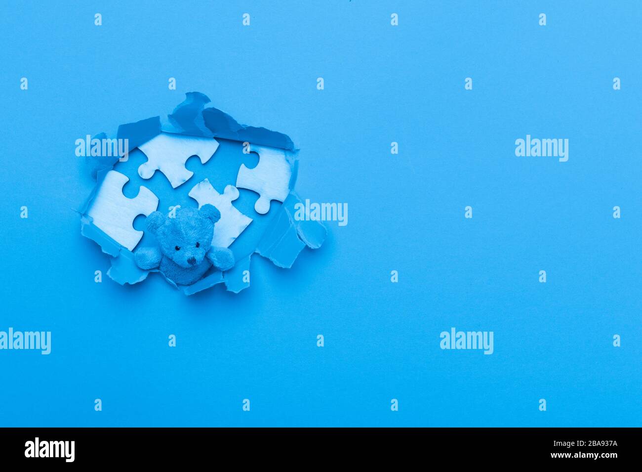 Teddy Bear and wooden Puzzle In Paper cut hole. World Autism Awareness ...
