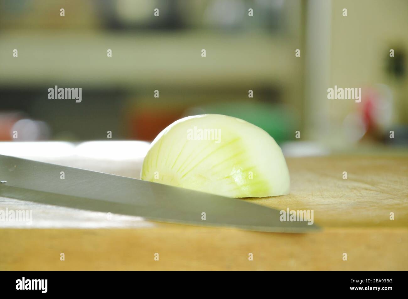 onion haft cut and knife prepare to cooking on wooden chop block Stock ...