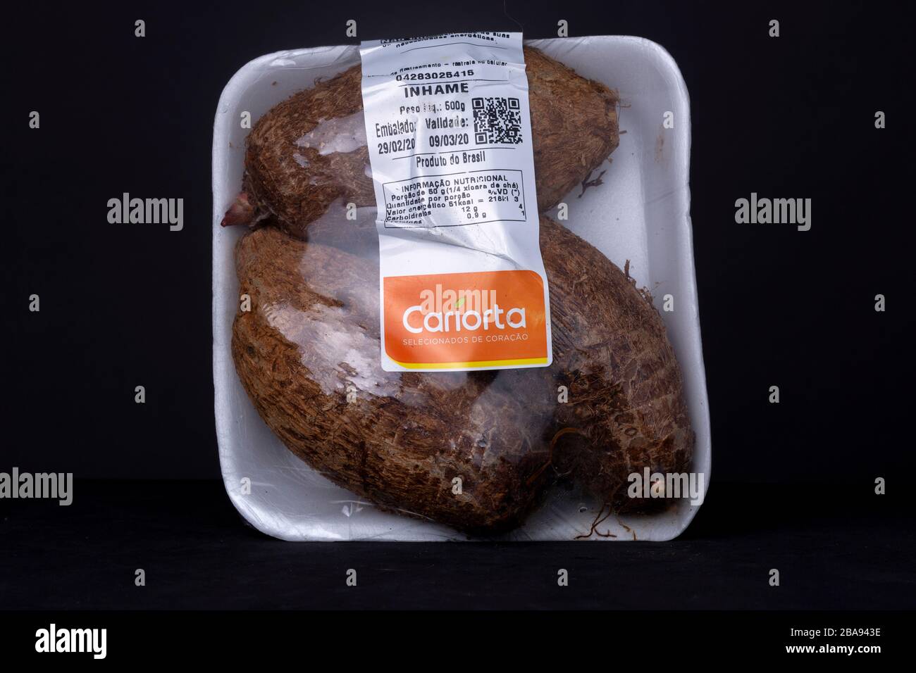 Packed lot of Brazilian Inhame or Yam in plastic wrap on white ...