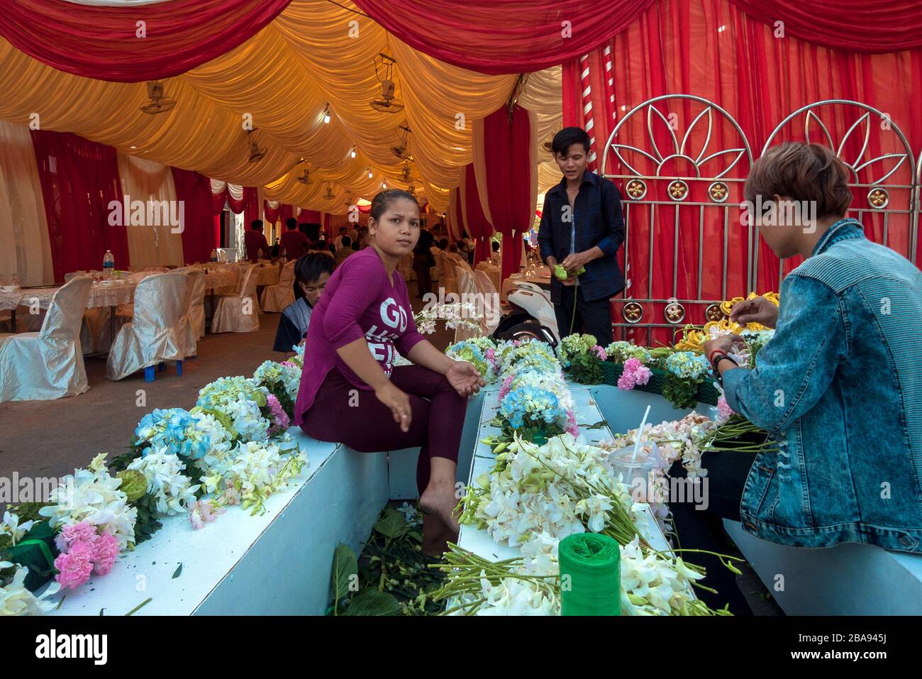 Kampot, Cambodia, Asia: a group of young people prepare floral ...