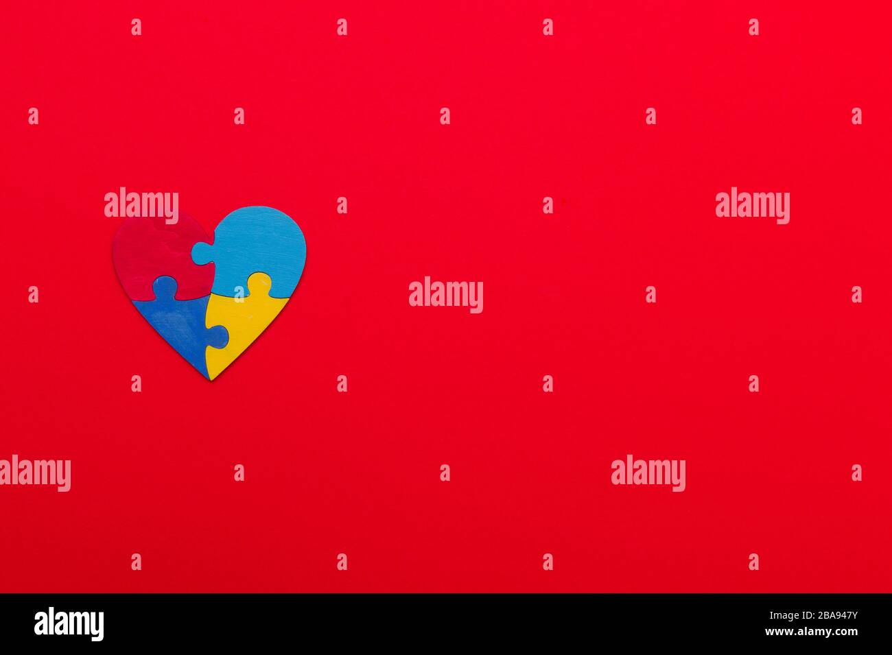 Colorful Puzzle Heart Shape On Red background World Autism Awareness ...