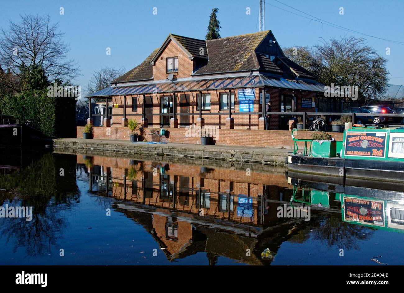 Canal boat with reflection in the water, Grand Union canal at Northolt ...