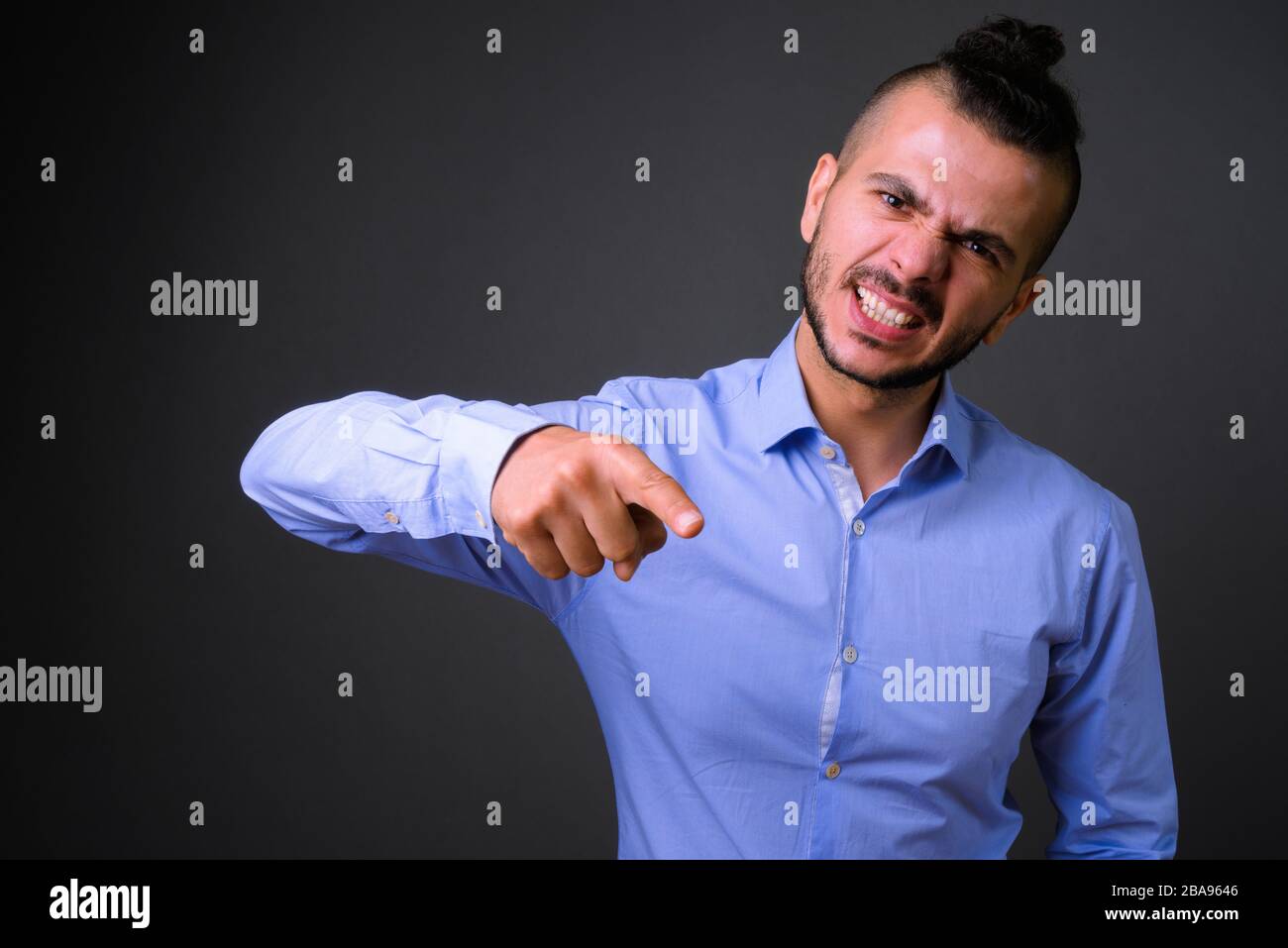 Face of angry bearded Turkish businessman pointing at camera Stock ...