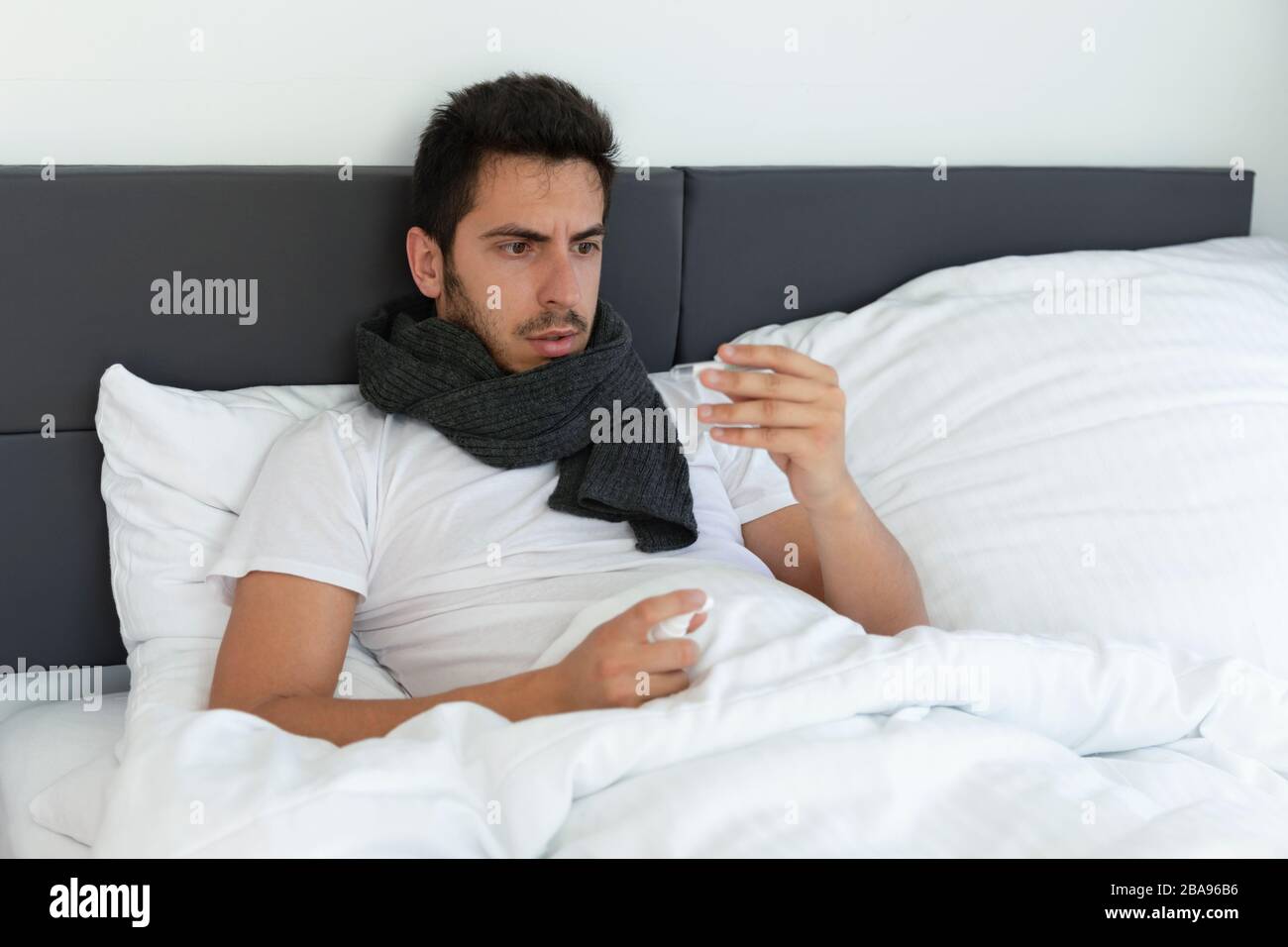 The man is sick, he has a fever and a cough. He is at home and trying ...