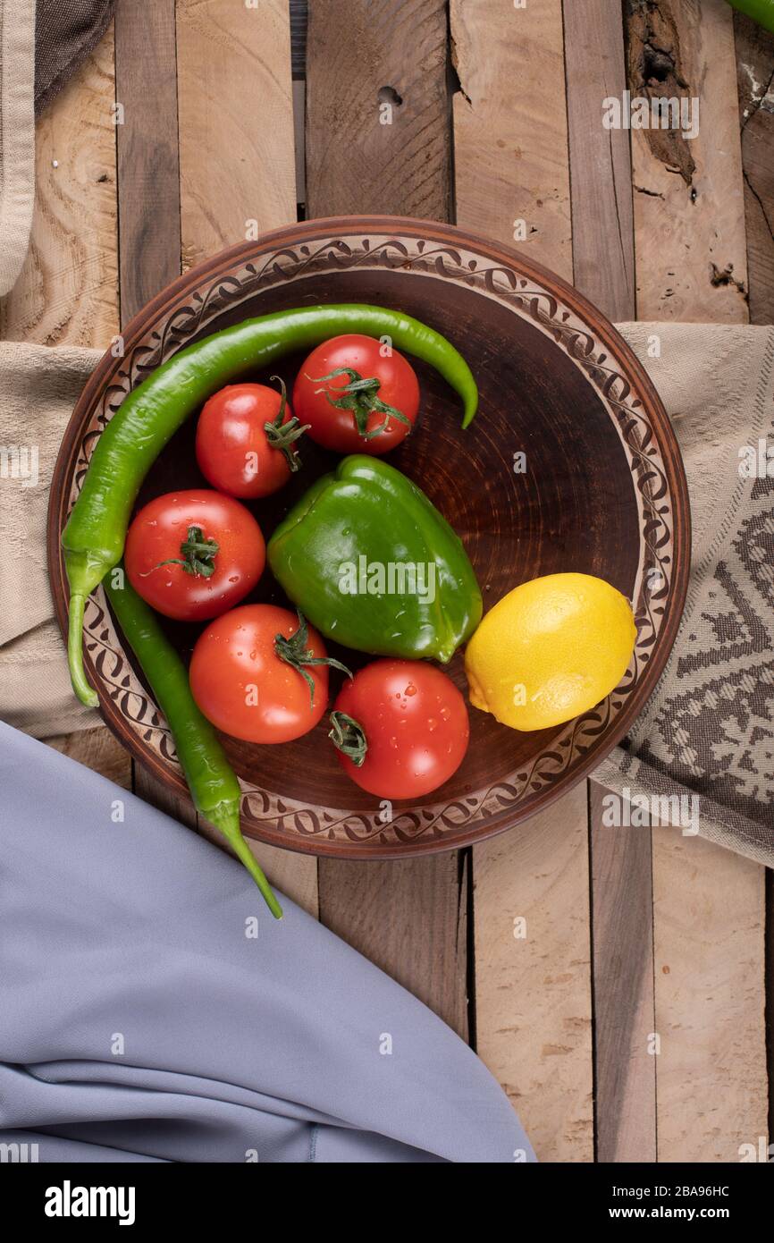 Tomato platter with pepper and lemon. Top view Stock Photo - Alamy