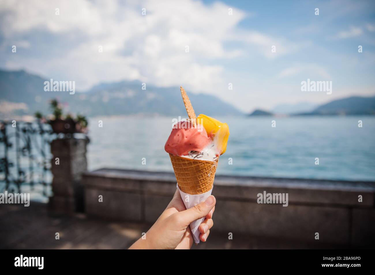 Hand holding cone with colorful delicious italian gelato ice-cream in ...