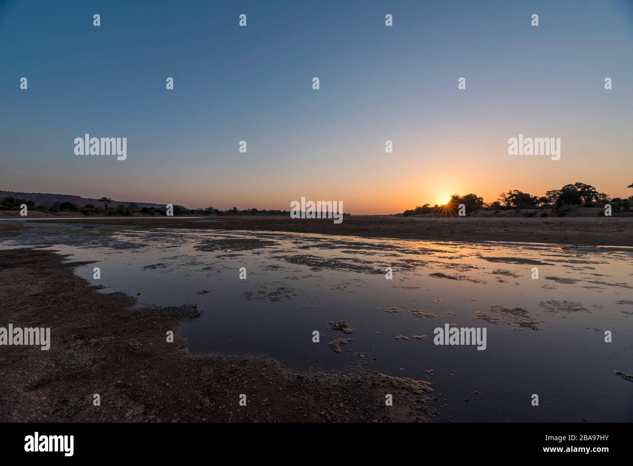 A sunset seen from the banks of the Runde river in Zimbabwe's ...