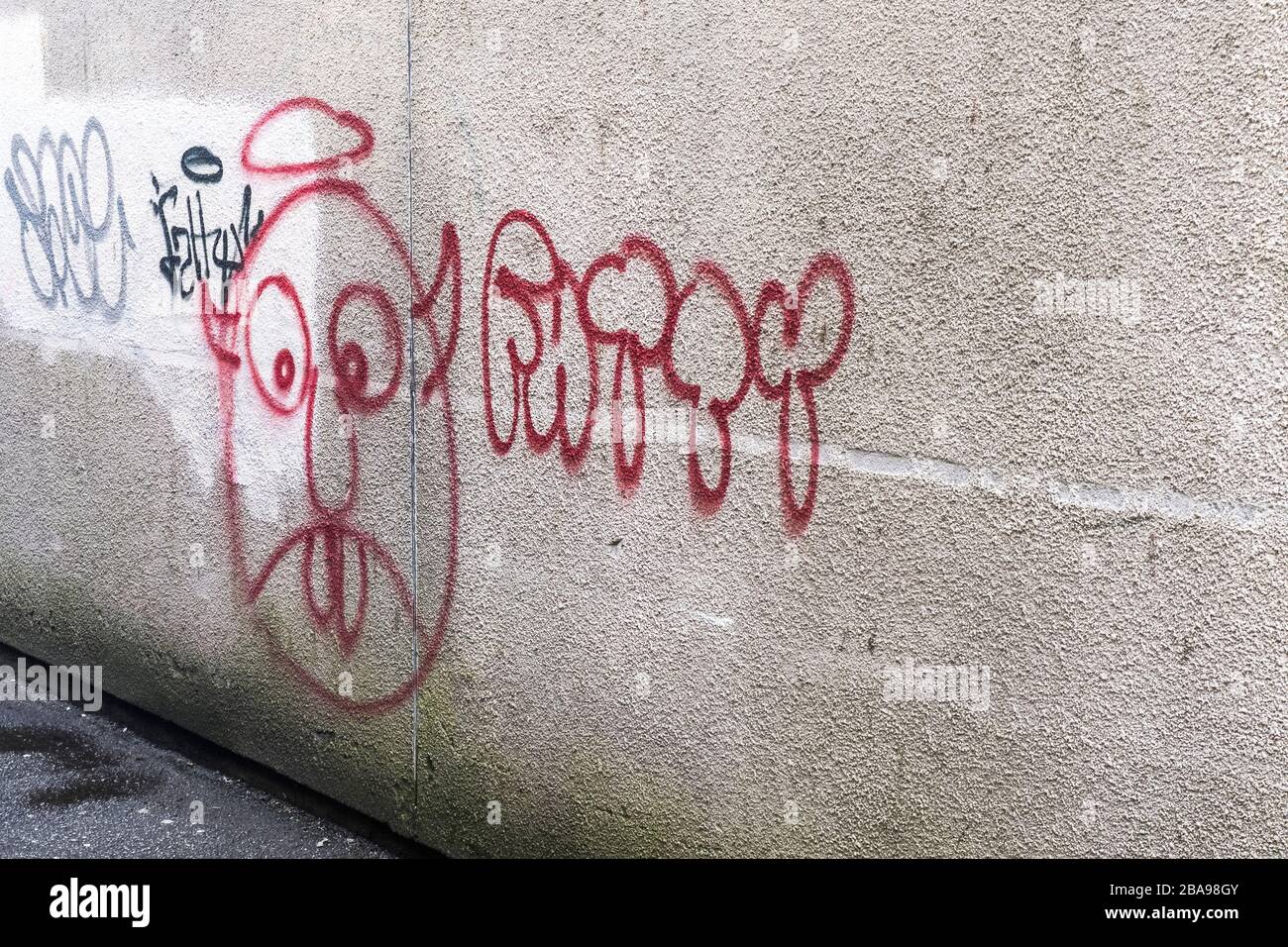 Ugly graffiti sprayed on a wall in Truro City centre in Cornwall Stock ...