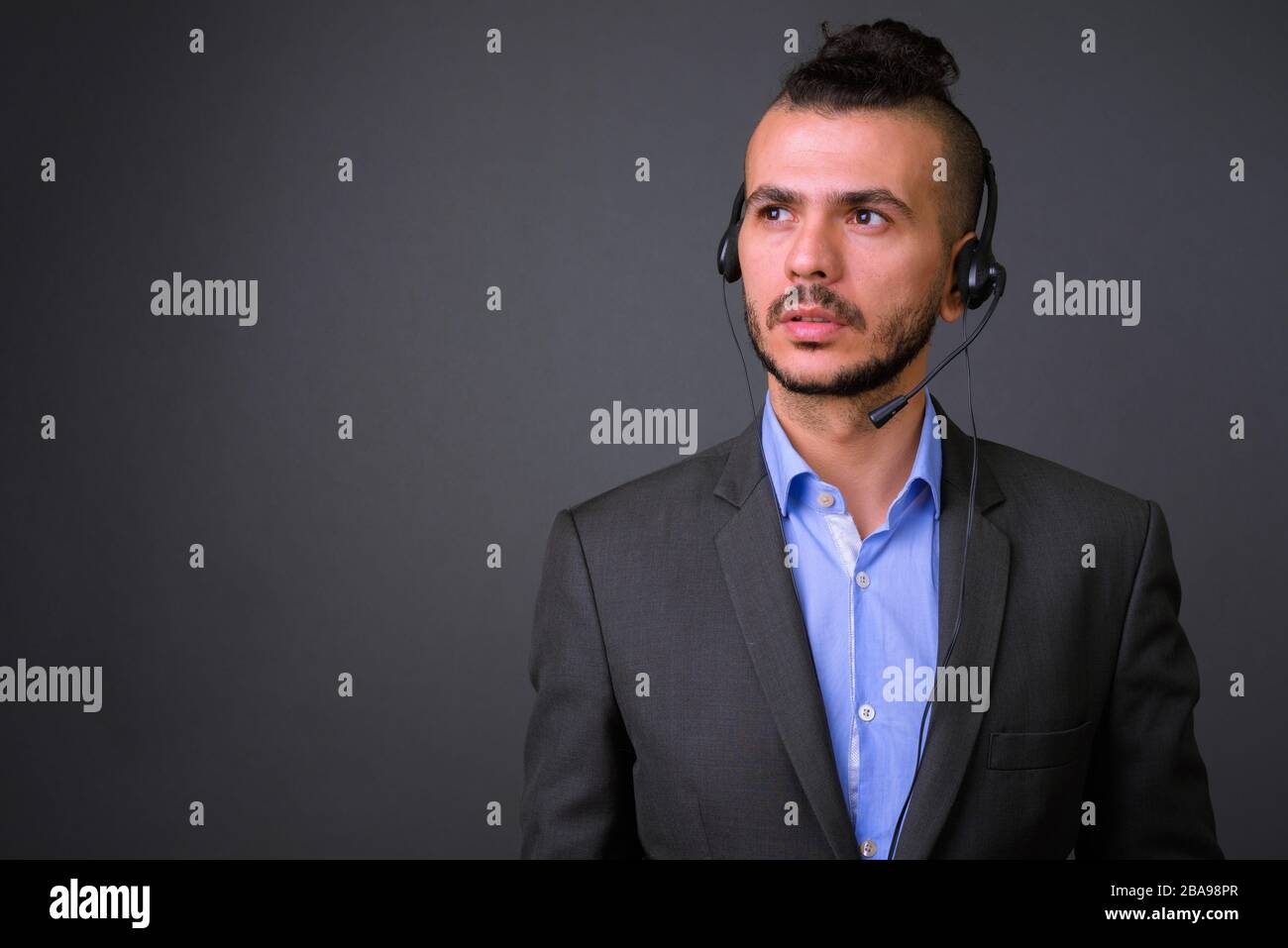 Face of handsome bearded Turkish businessman as call center ...