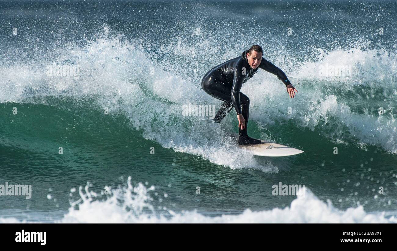 A panoramic image of surfing action at Fistral in Newquay in Cornwall ...
