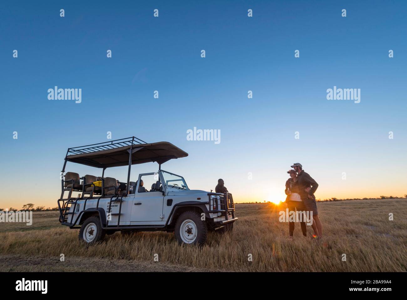 A happy couple at sunset on safari in Zimbabwe Stock Photo - Alamy