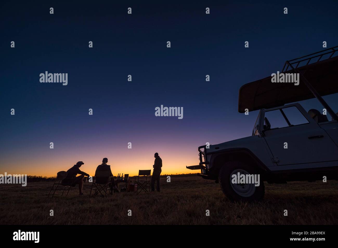 A happy couple at sunset on safari in Zimbabwe Stock Photo - Alamy