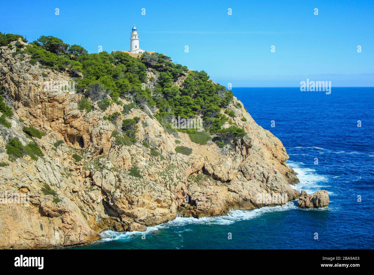 Faro de Capdepera lighthouse on top of cliffs in Cala Gat near Cala ...