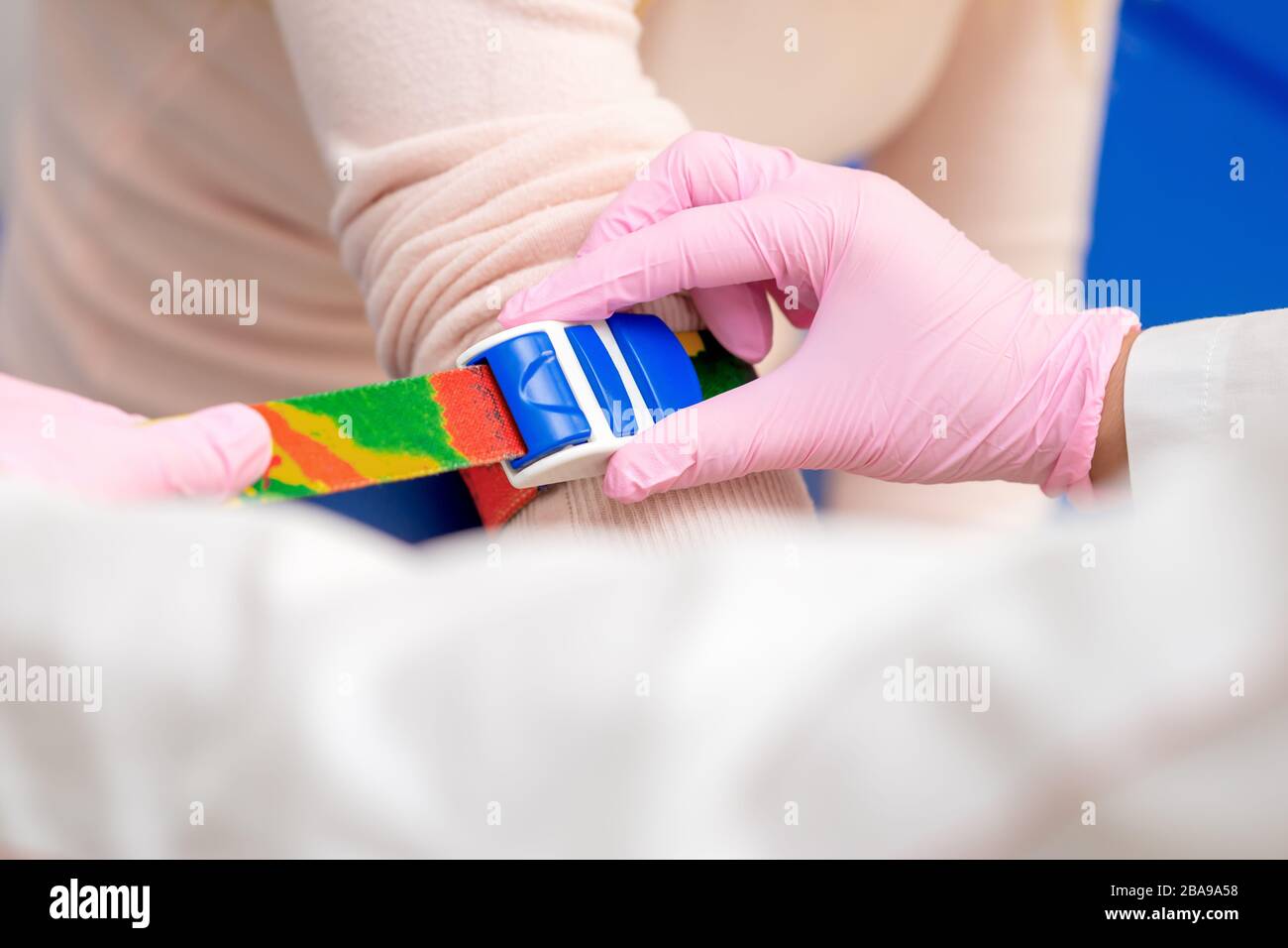 Nurse tightens the harness on the arm to take blood from a vein for ...