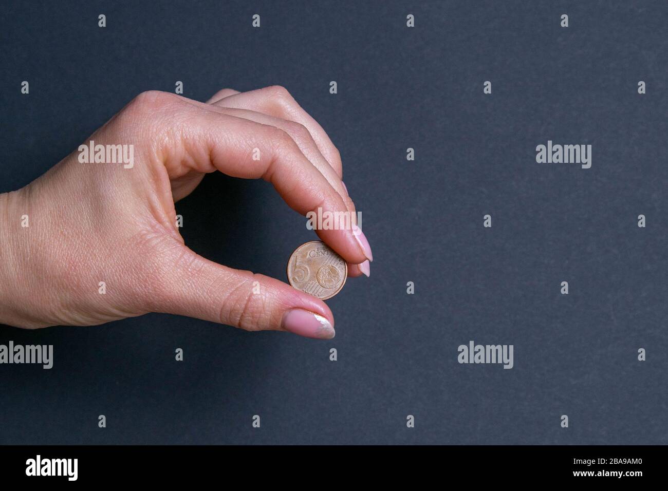 Hand sign by holding a coin, isolated on black background Stock Photo ...