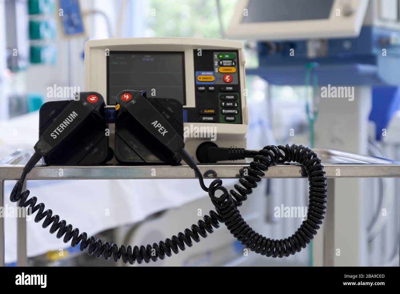 Defibrillator, on background medical ventilator in ICU in hospital, a ...
