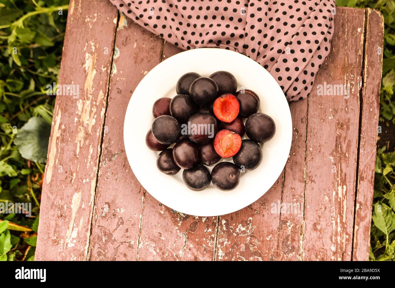 Fresh plums on old wooden table Stock Photo - Alamy