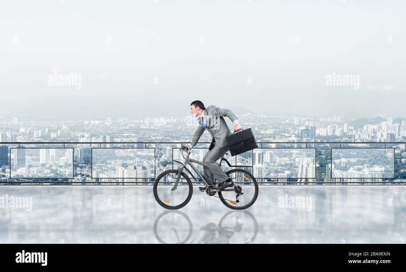 Man riding bicycle on penthouse balcony Stock Photo - Alamy