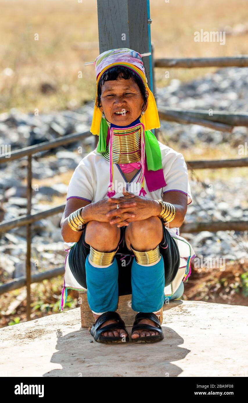 Padaung woman in traditional dress and with metal rings on her neck ...