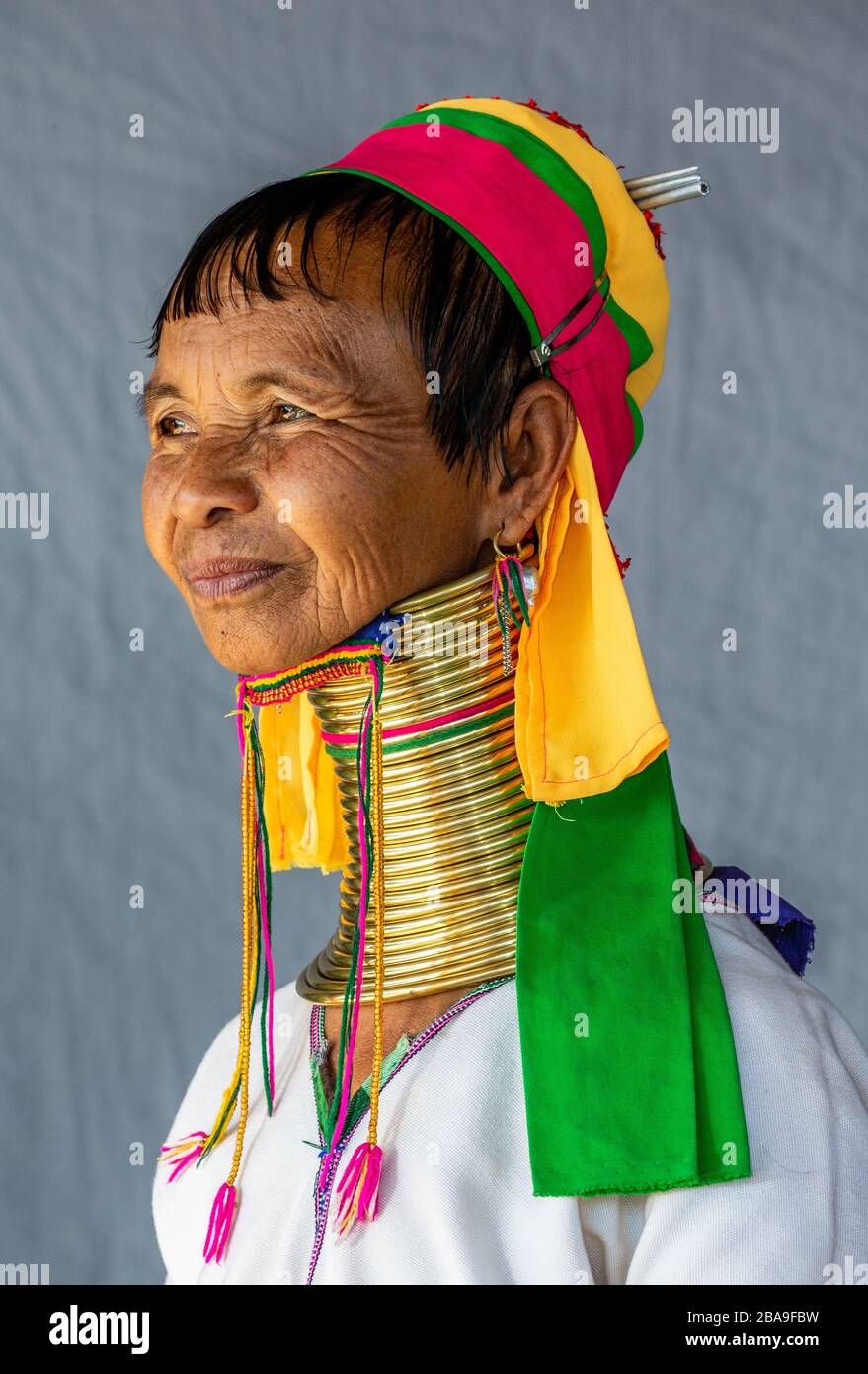 Portrait of an old Padaung woman in traditional dress and with metal ...
