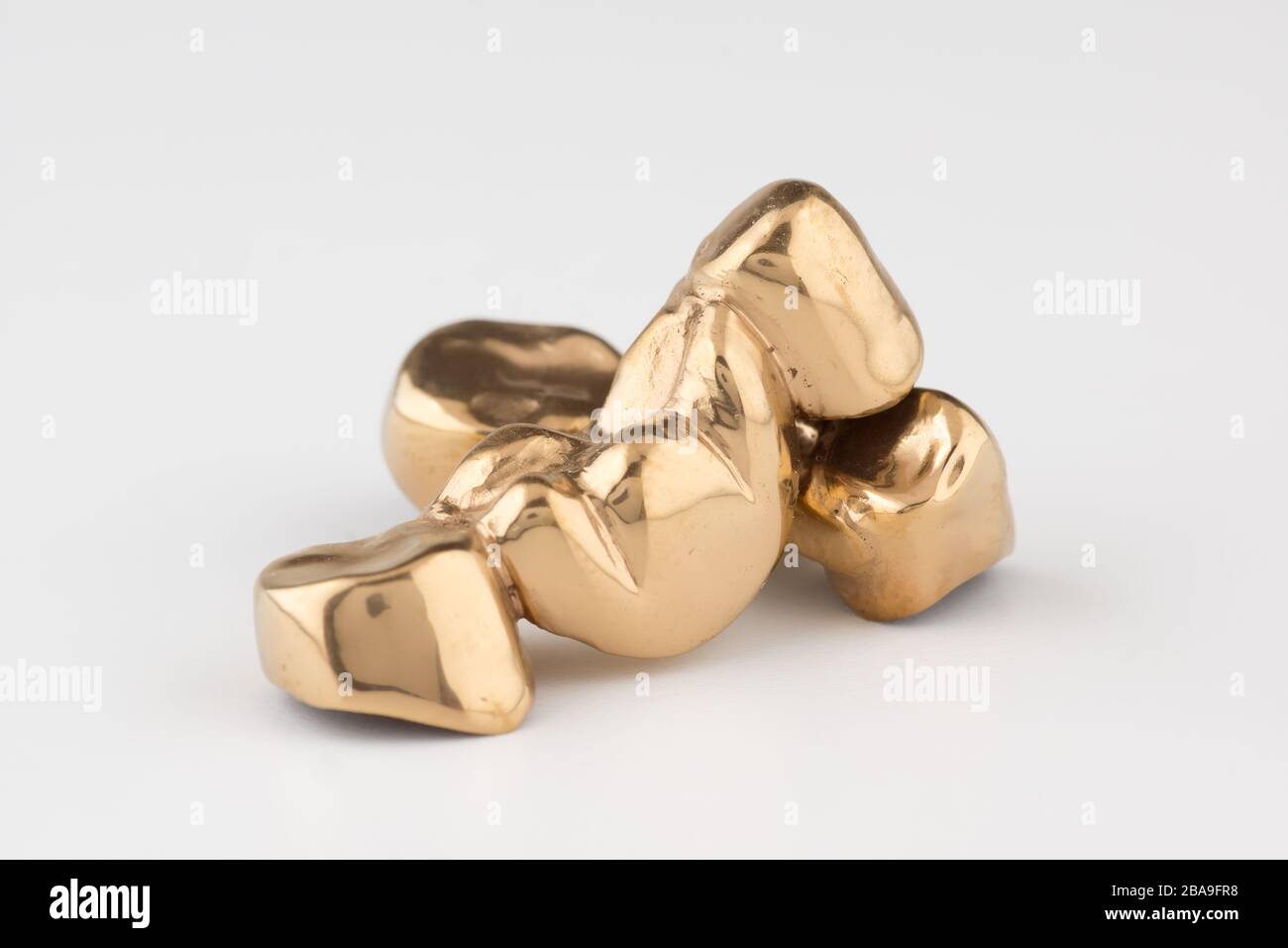 Steel artificial dental crown for dentition restoration Stock Photo - Alamy