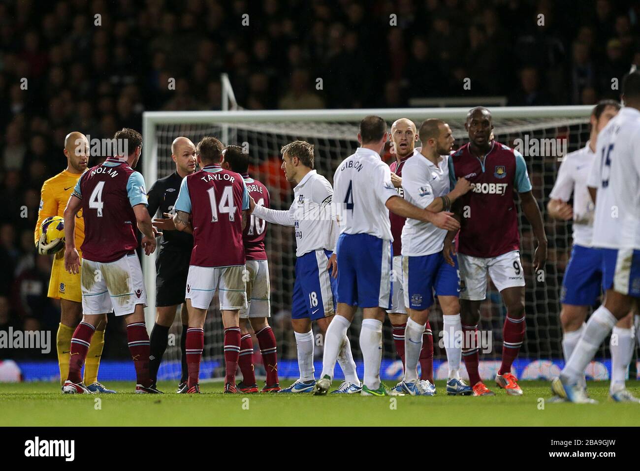 West Ham United's Carlton Cole (right, number 9) reacts as he is shown ...