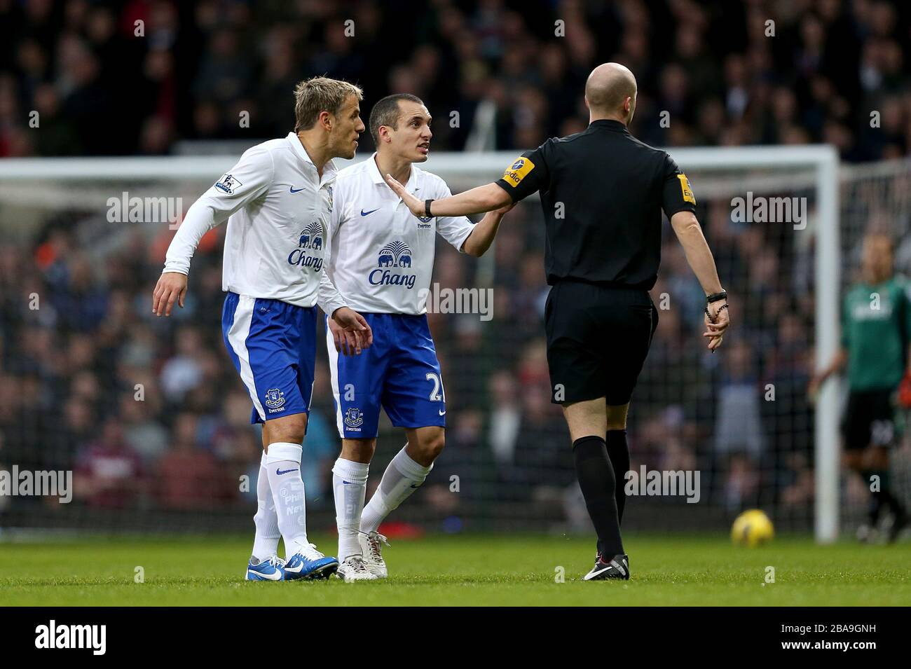 Referee Anthony Taylor ignores pleas from Everton's Phil Neville (left ...