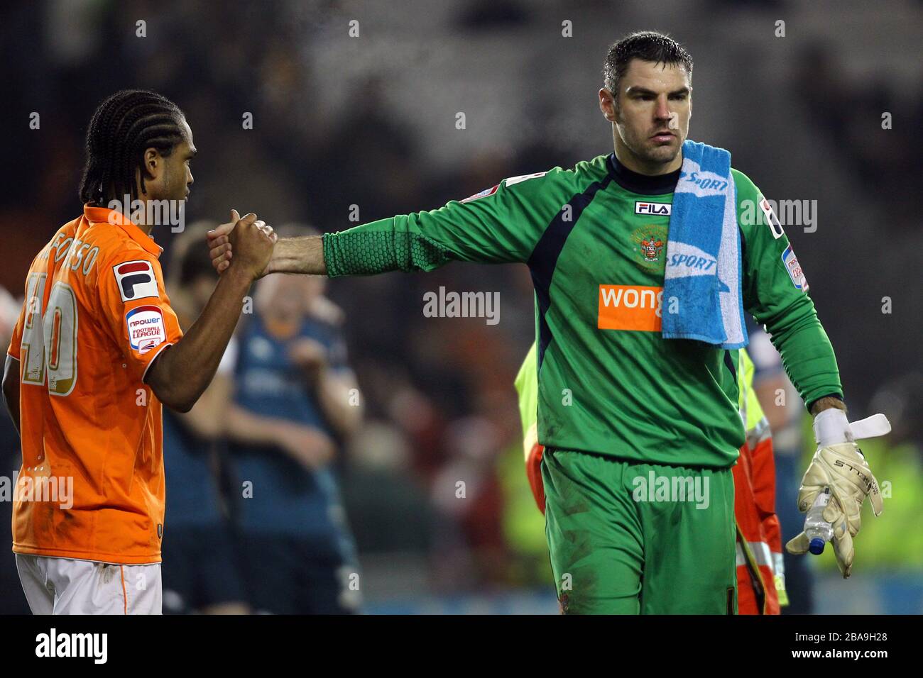Blackpool goalkeeper Matthew Gilks (right) shakes hands with teammate ...