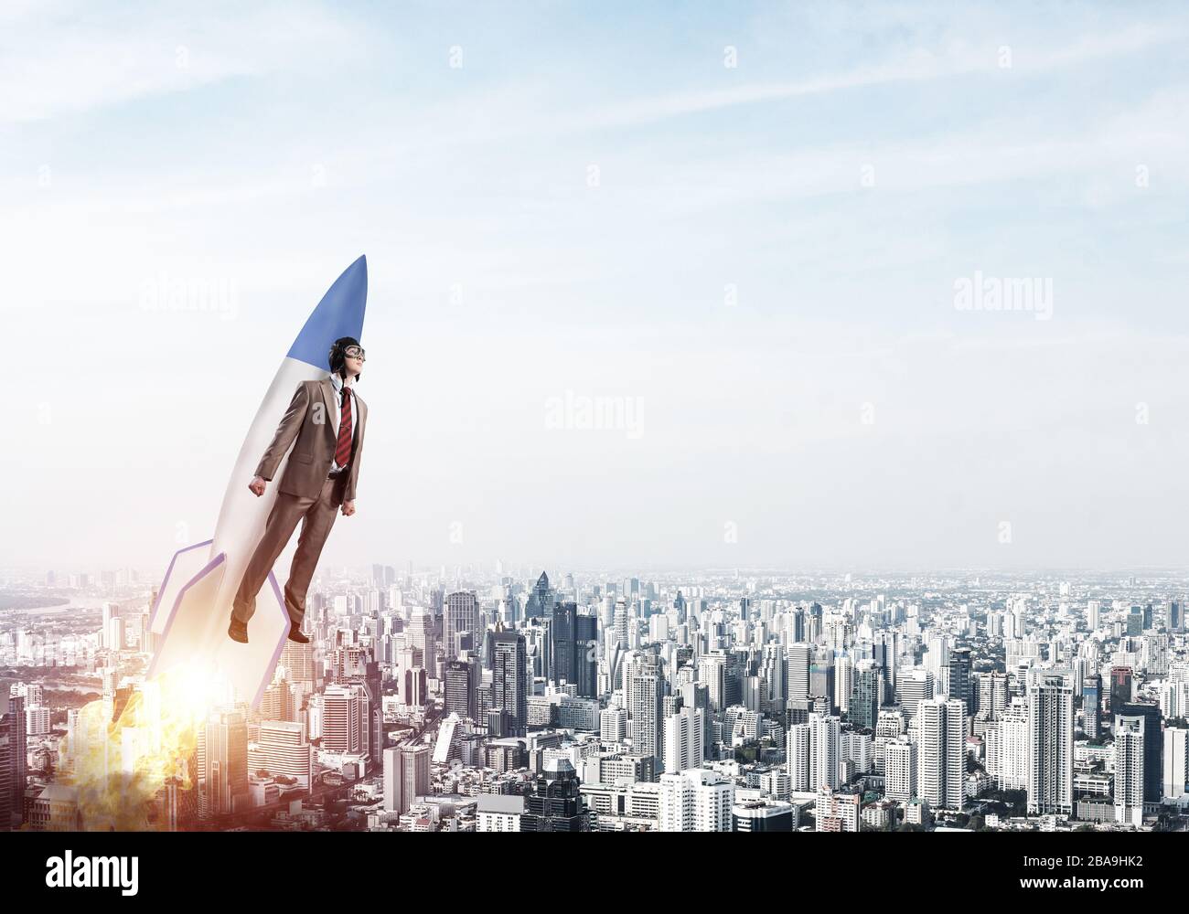Business person in aviator hat flying on rocket Stock Photo - Alamy