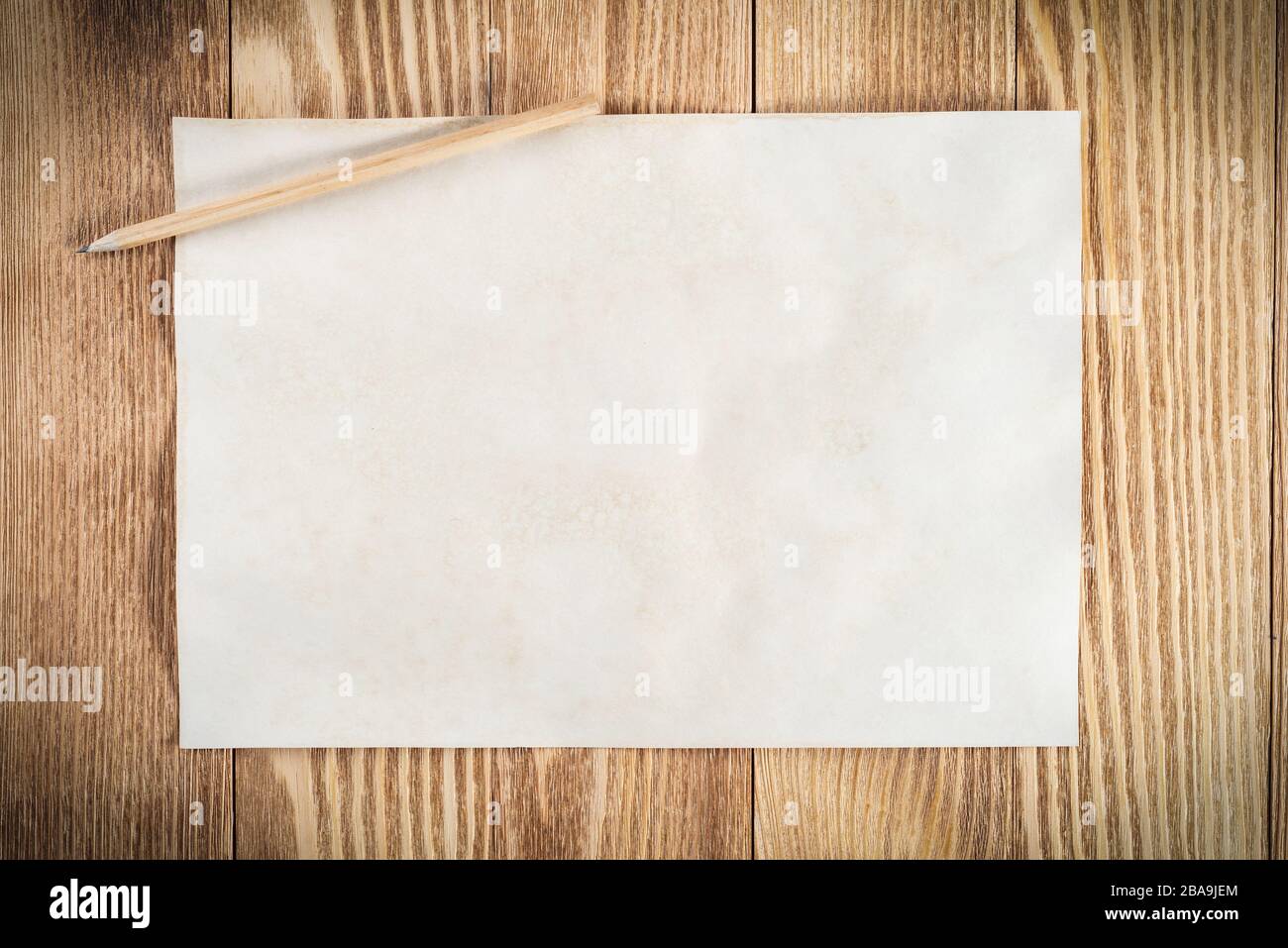 Sheet of paper lying on wooden table Stock Photo - Alamy