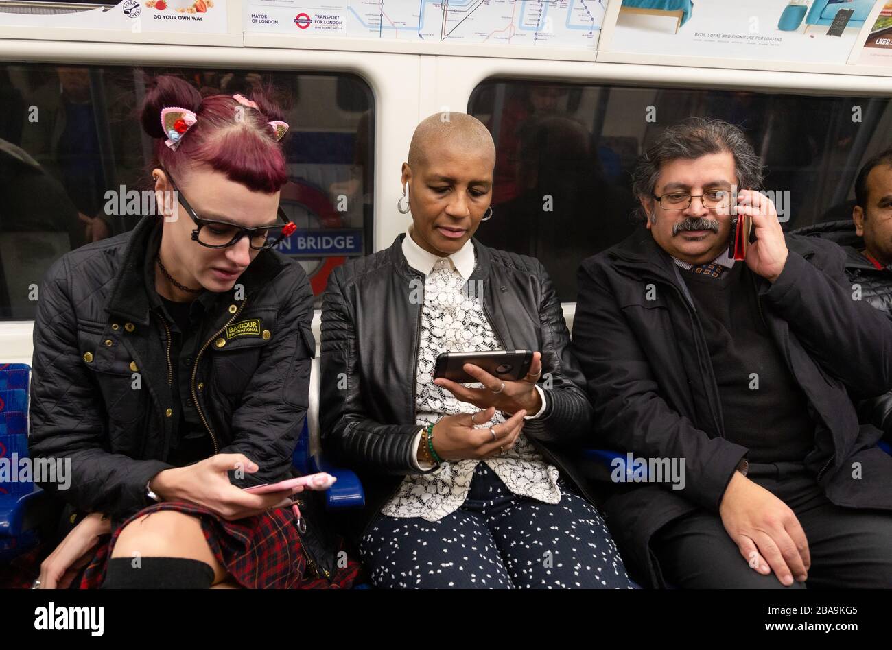 Passengers using their smartphones and making phone calls on the ...