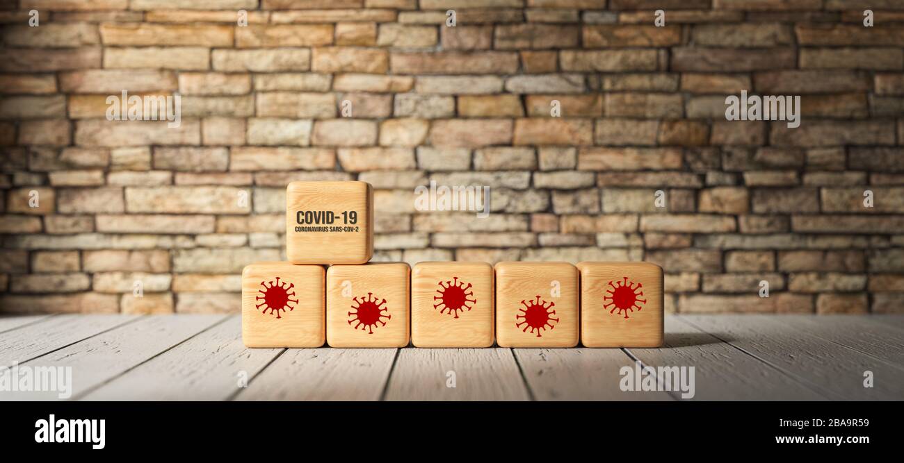 cubes with message COVID-19 and virus symbols in front of brick wall ...