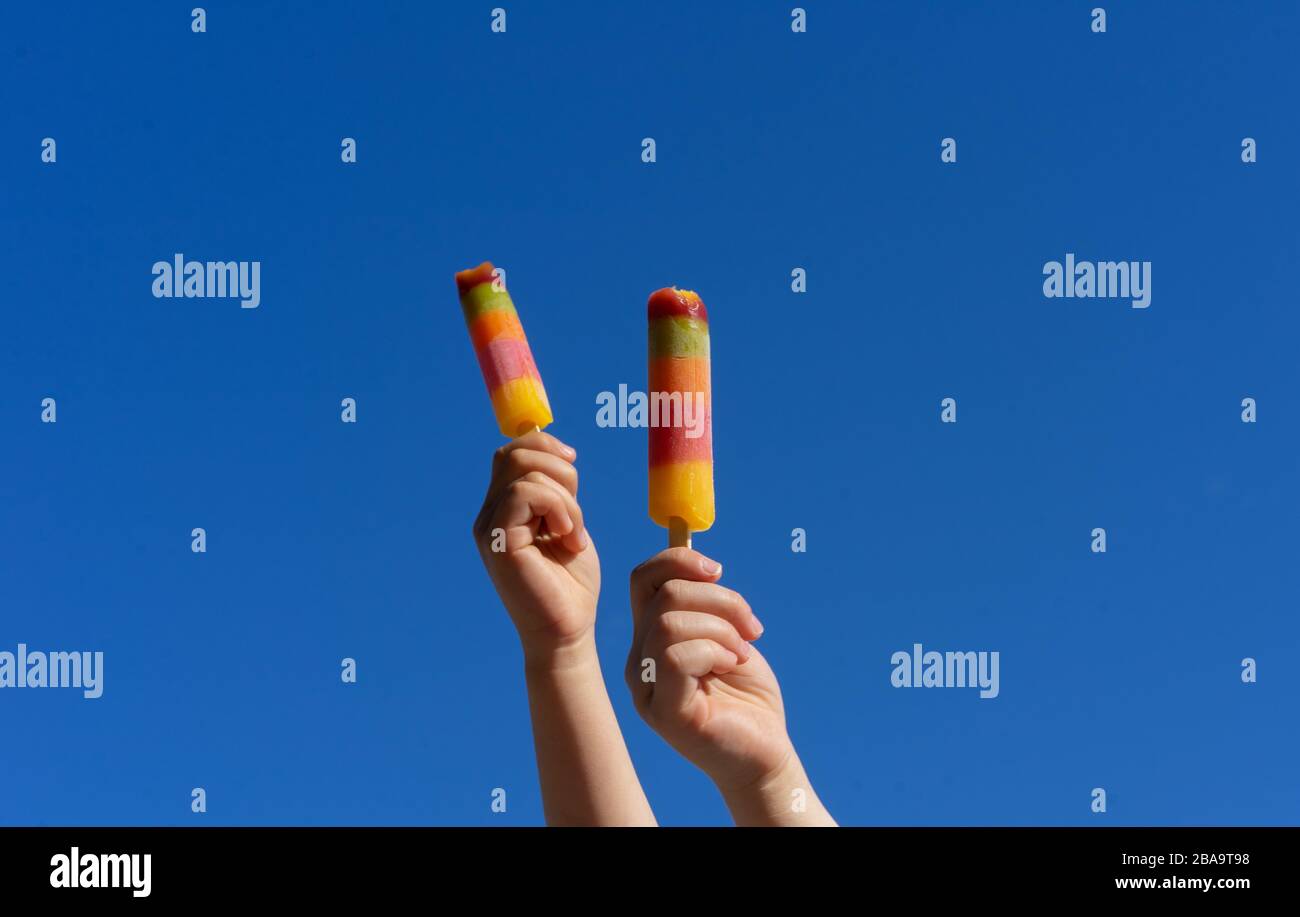 Two ice lollies on the blue sky Stock Photo - Alamy