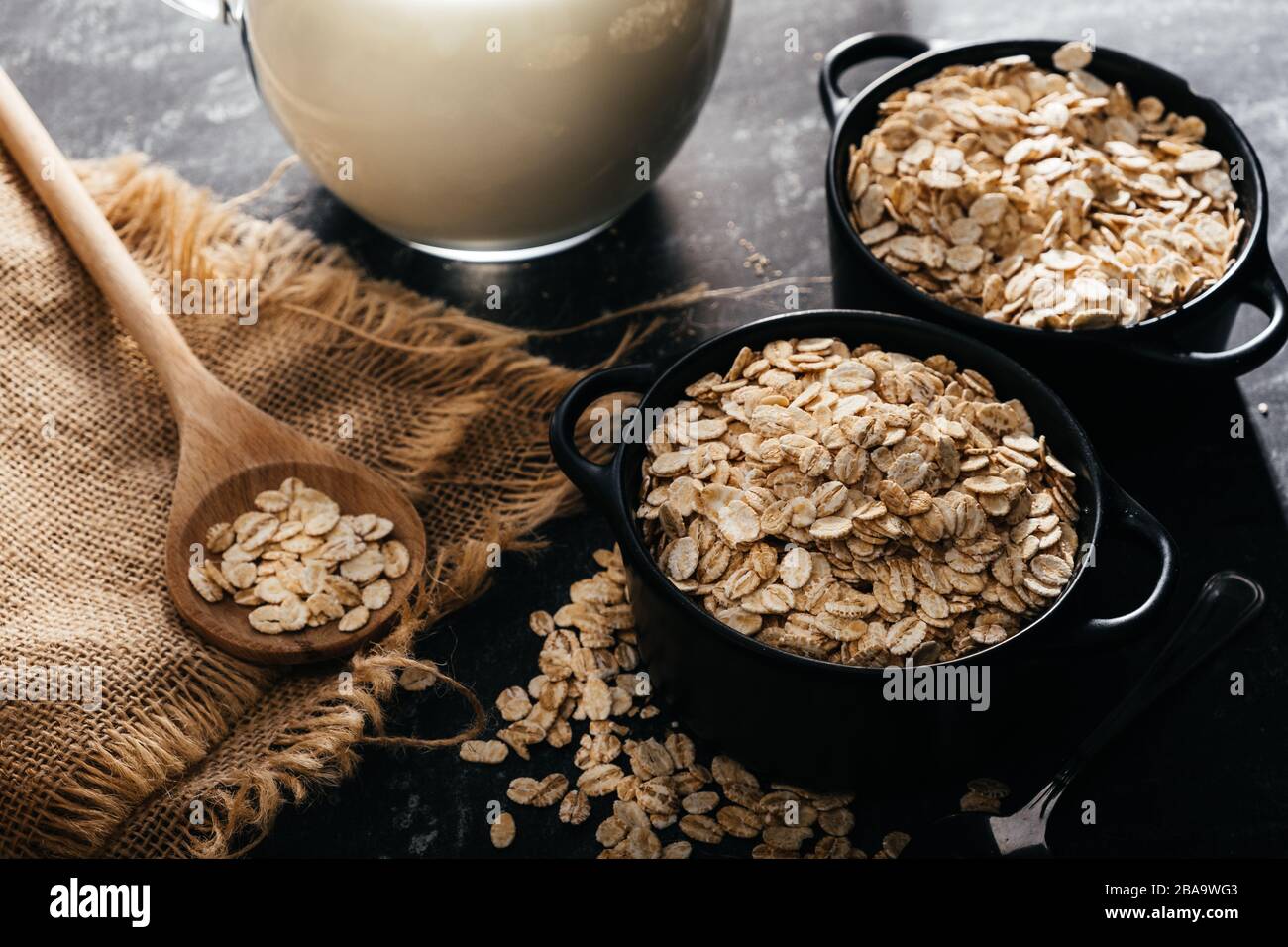 Breakfast with fibers for a balanced diet. Oat photo. Black bowl and ...
