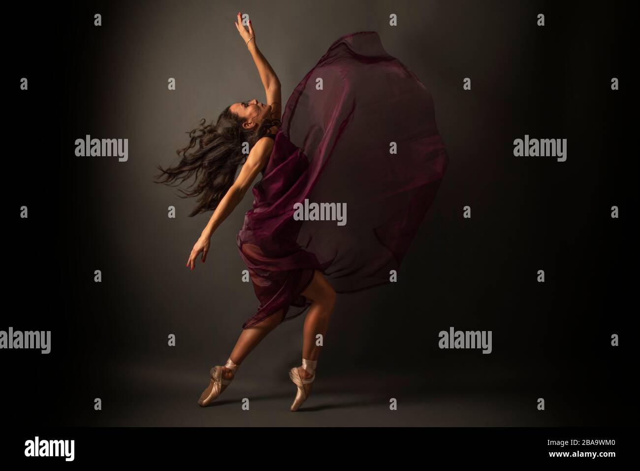 Graceful ballet dancer or classic ballerina dancing isolated on grey ...