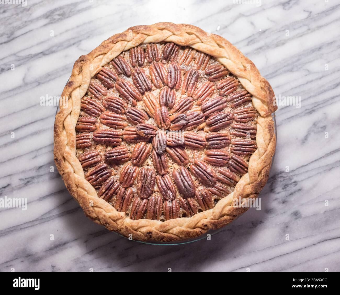 Swirled Pecan Pie with Braided Crust on a Marble Pastry Board Stock ...