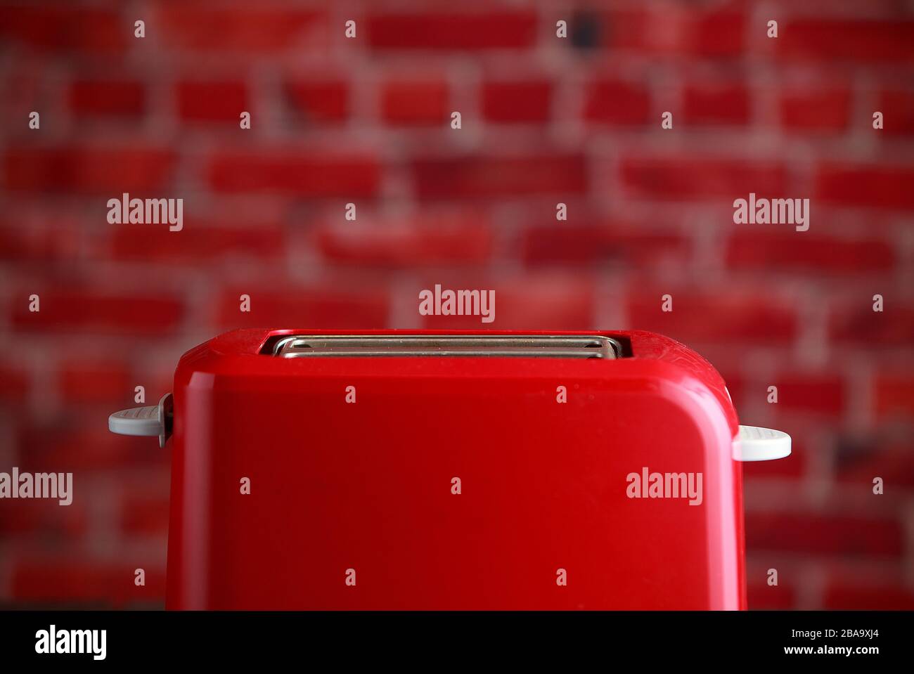 red toaster on bricks wall background. Kitchen equipment Stock Photo ...