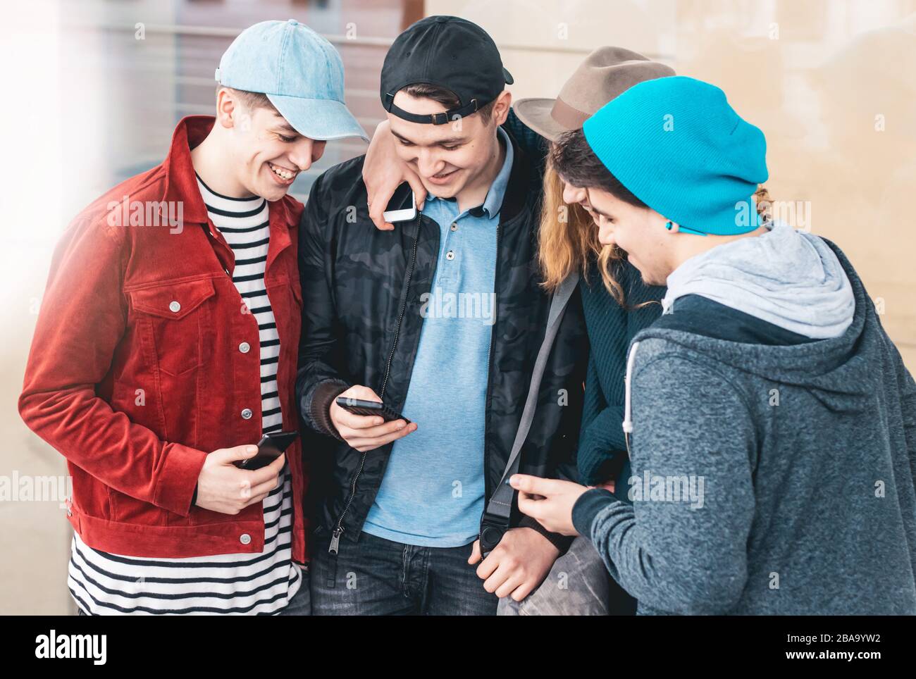Group of young people watching their smartphones having fun. Young ...
